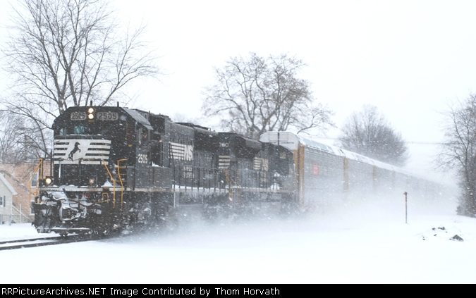 NS 11J kicks up the snow as it heads west over the LEHL